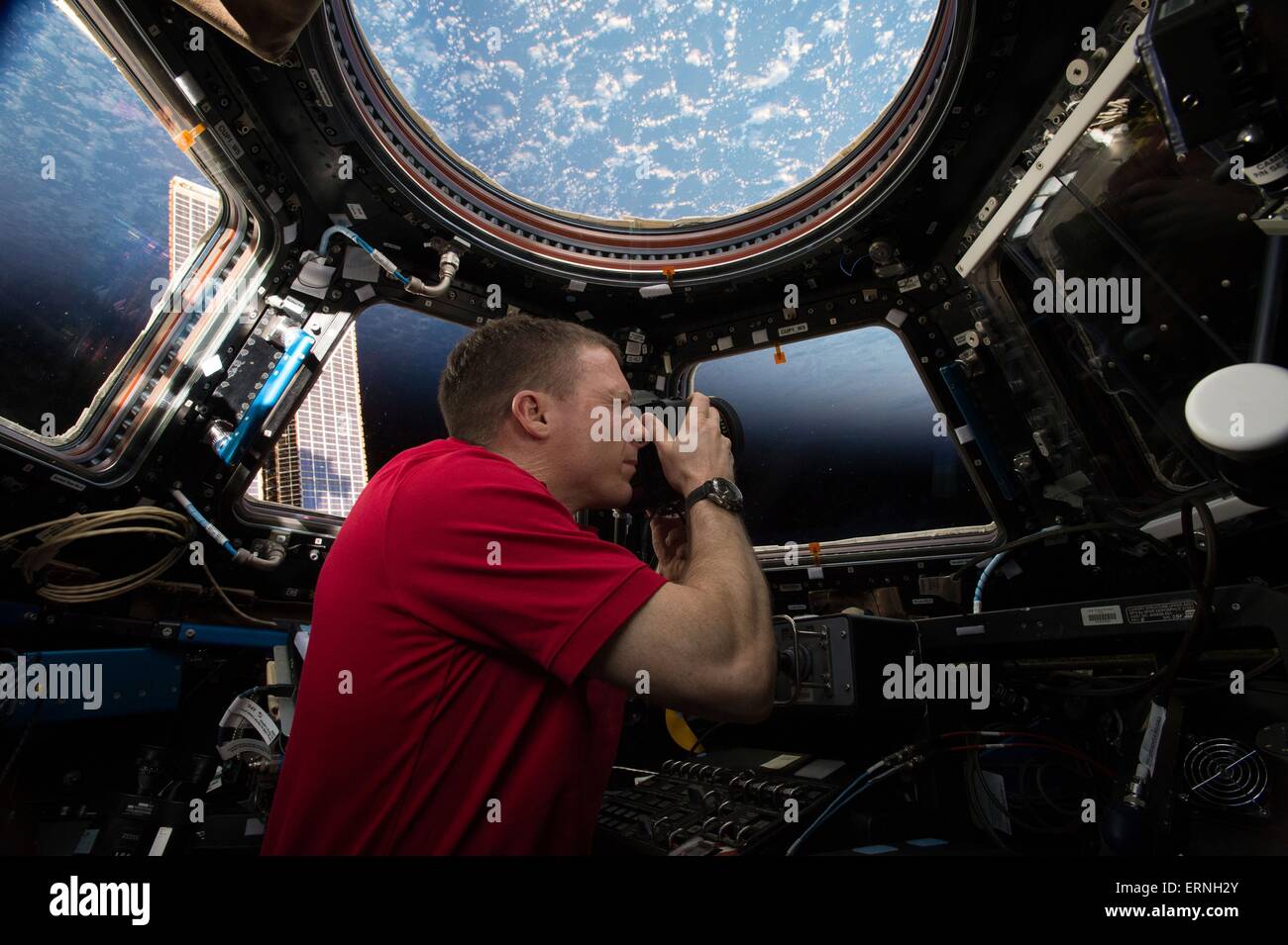 International Space Station Expedition 43 commander and NASA astronaut Terry Virts takes photos ...