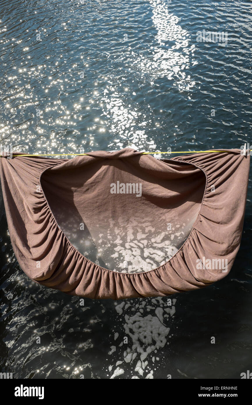 Brown Hanging Sheet over Sparkling Water Stock Photo - Alamy