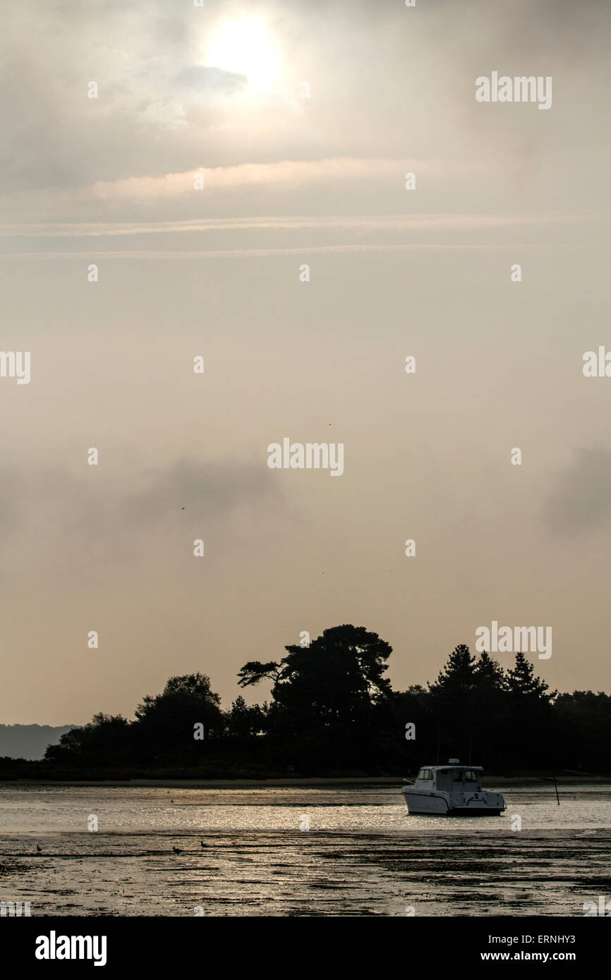 boat near island in bay at sunset Stock Photo - Alamy