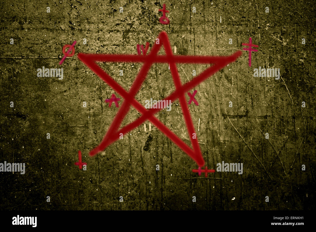 Altered photo of a red pentagram with symbols on a rough concrete wall ...