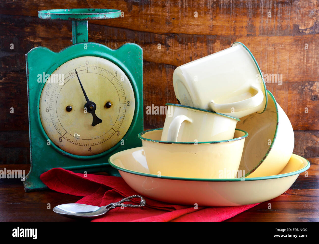 Vintage kitchen scales and tin cups and pans on dark reclaimed wood ...