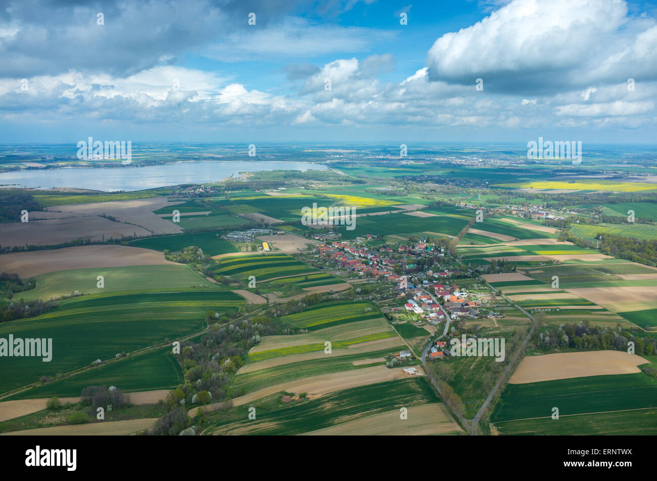 Aerial view on a small village surrounded by green fields Stock Photo ...