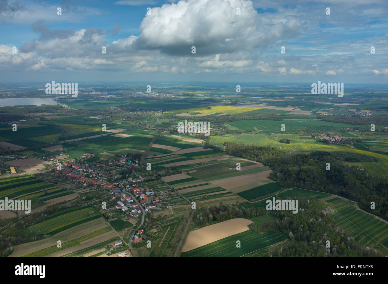 Aerial view on a small village surrounded by green fields Stock Photo ...