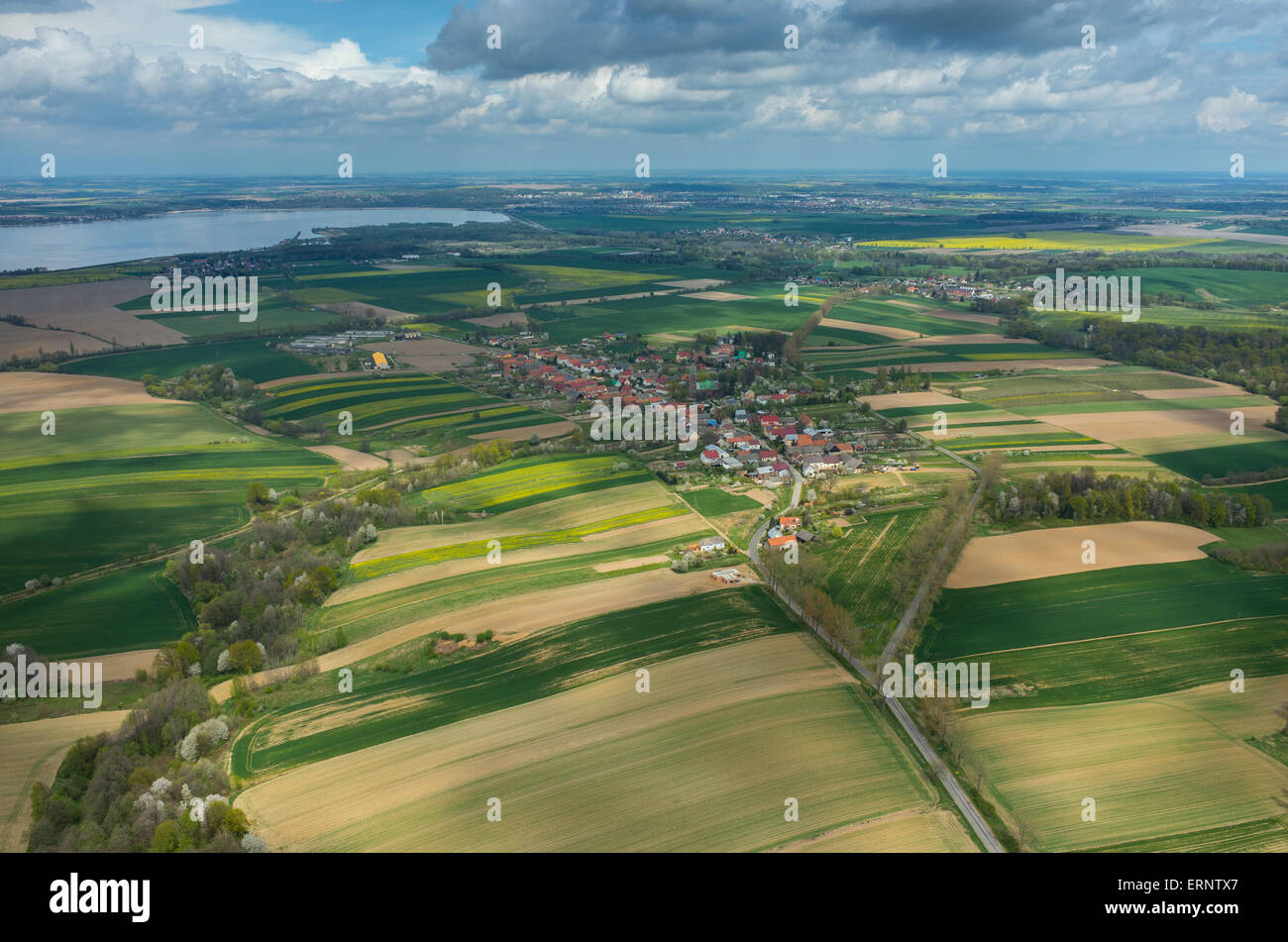 Aerial view on a small village surrounded by green fields Stock Photo ...