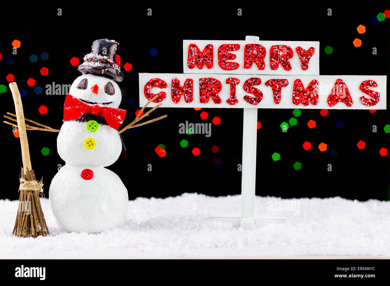 Snowman with a Merry Christmas signpost, bokeh lights Stock Photo - Alamy