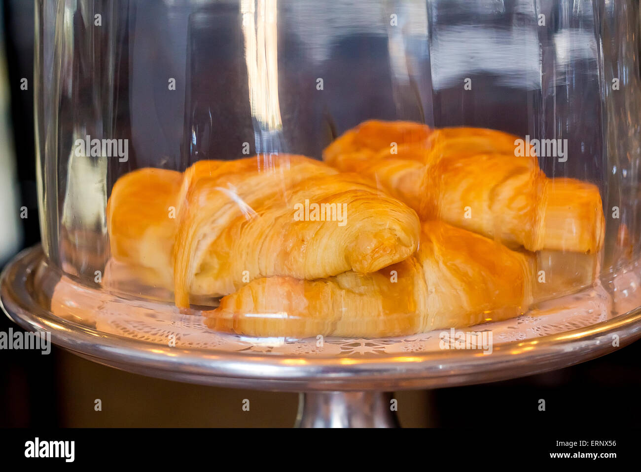 Tasty flaky plain croissants in bakery display case Stock Photo - Alamy