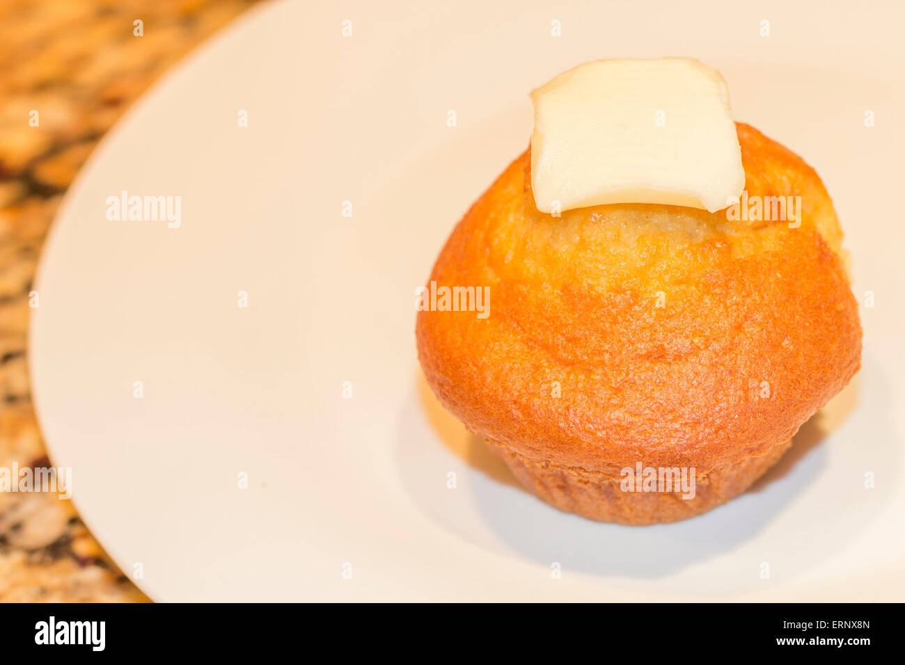 Single fresh corn muffin with slice of butter Stock Photo - Alamy