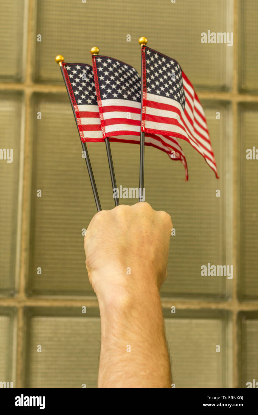 Waving three American flags in support the United States and freedom ...