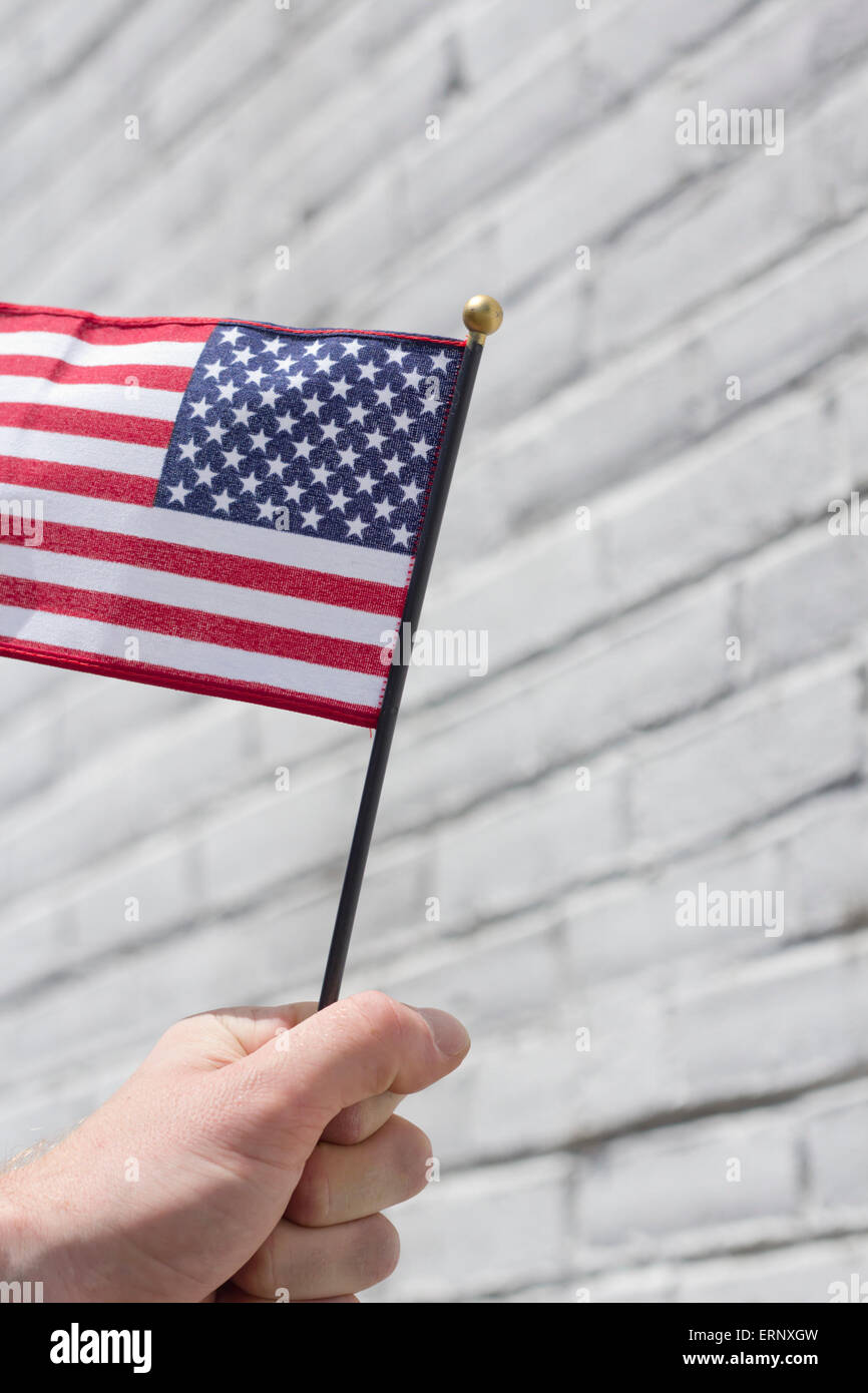 Waving three American flags in support the United States and freedom ...