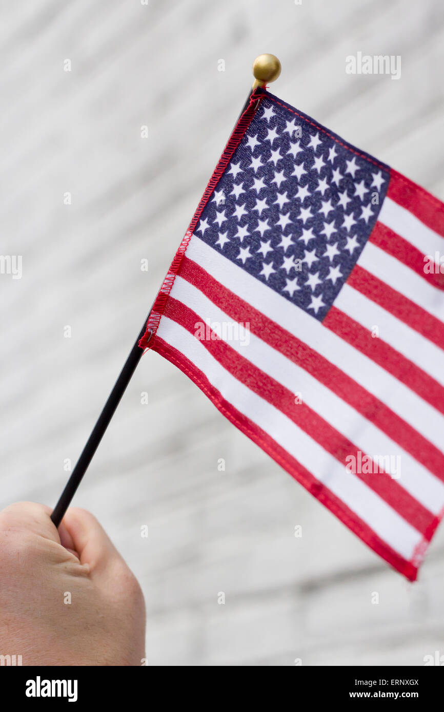 Waving three American flags in support the United States and freedom ...