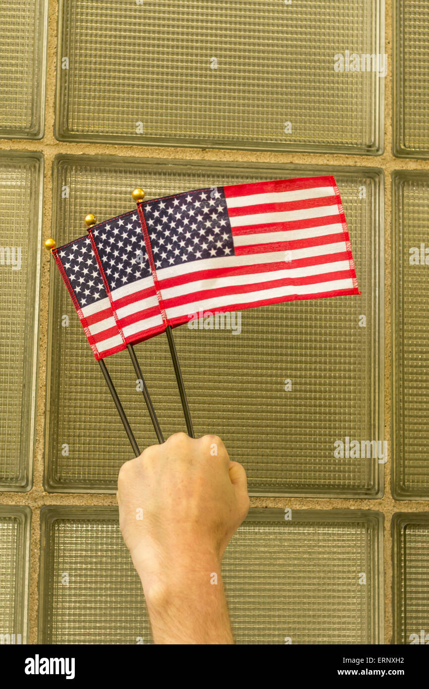 Waving three American flags in support the United States and freedom ...
