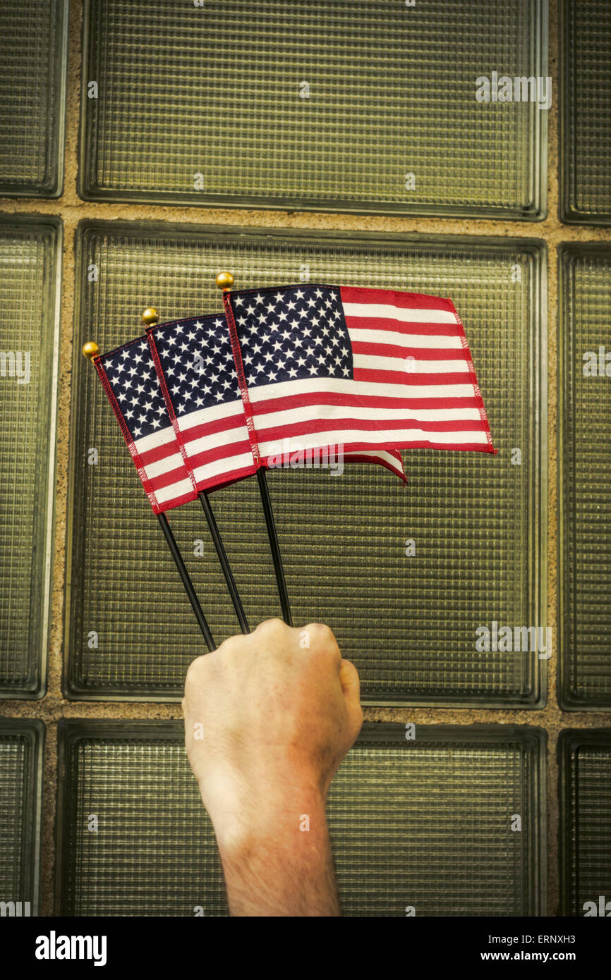 Waving three American flags in support the United States and freedom ...