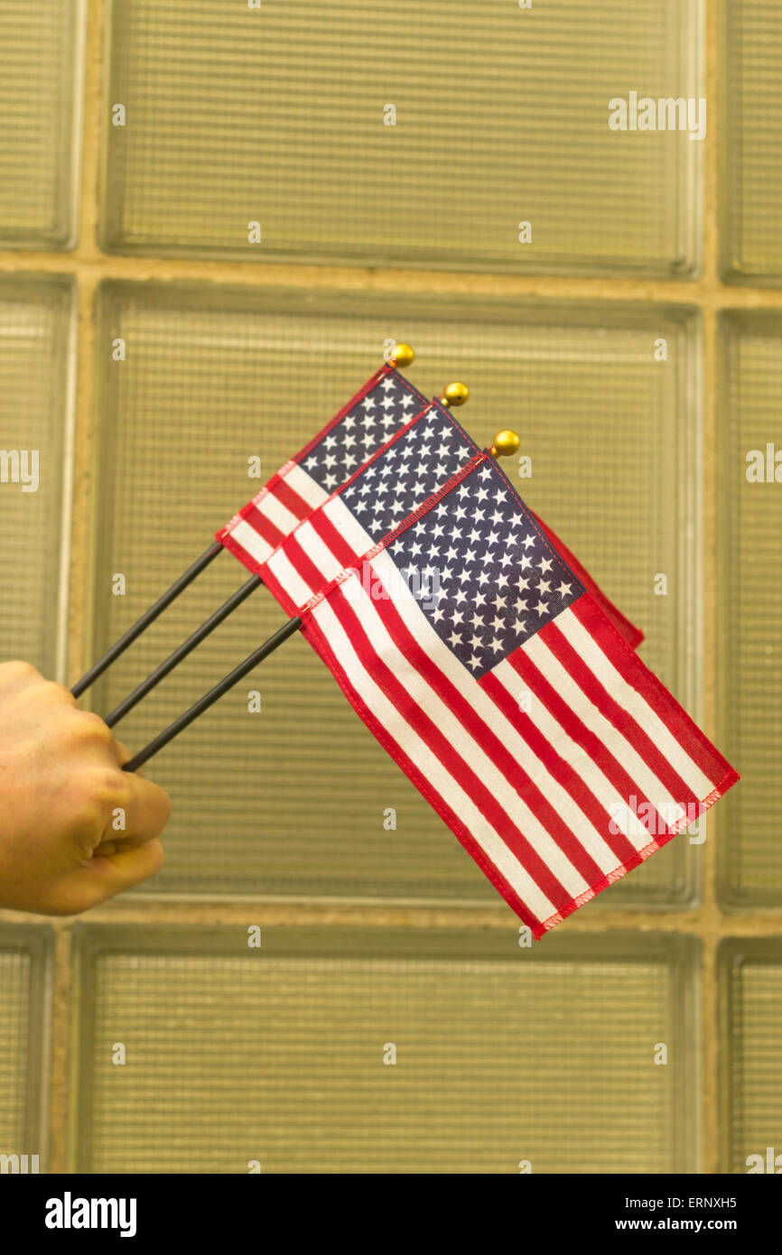 Waving three American flags in support the United States and freedom ...