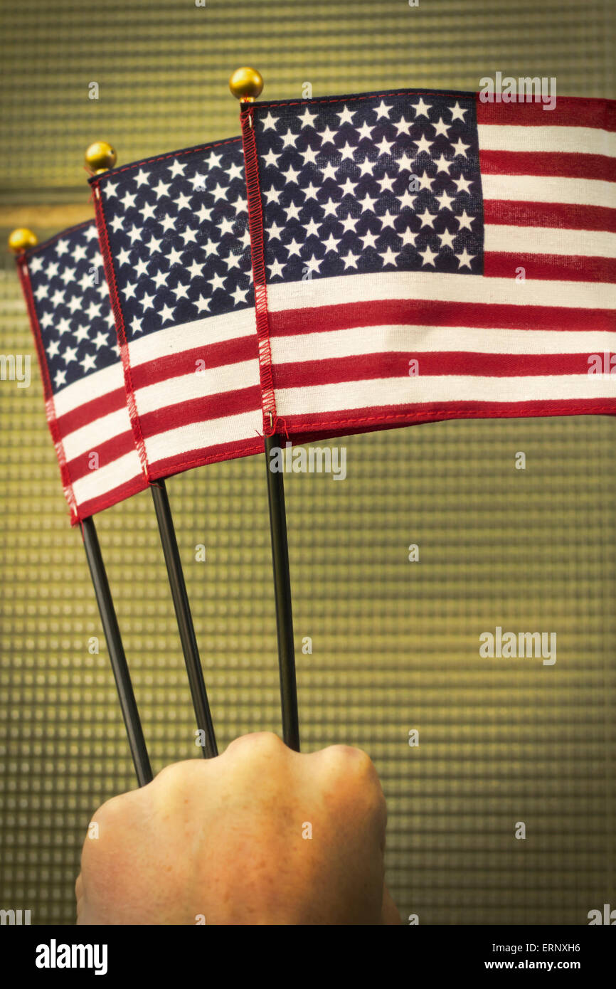 Waving three American flags in support the United States and freedom ...