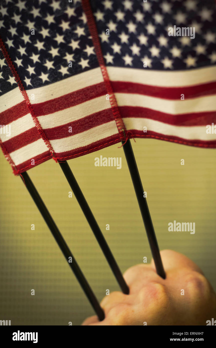 Waving three American flags in support the United States and freedom ...