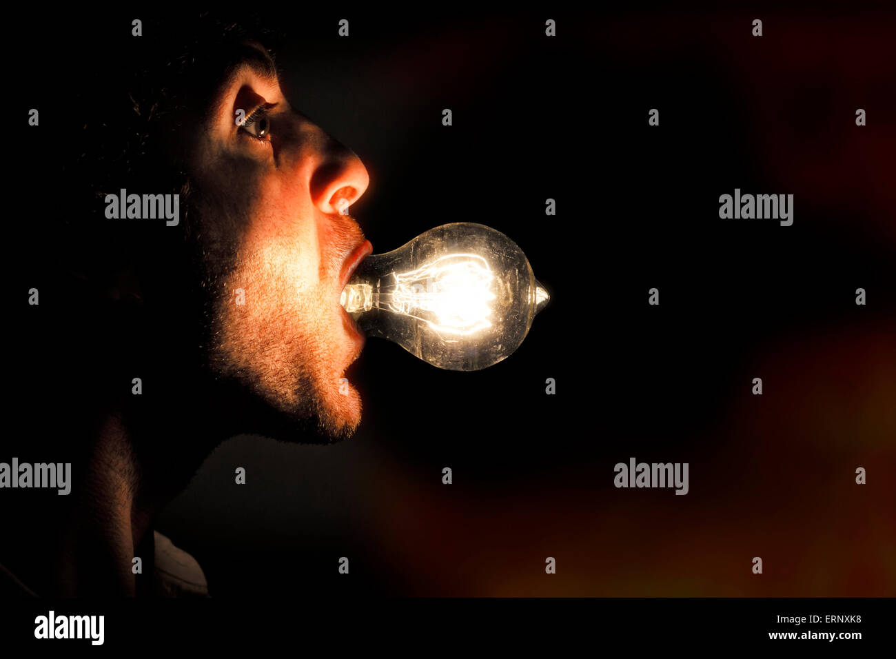 Decorative antique edison style filament light bulb coming out of man's ...