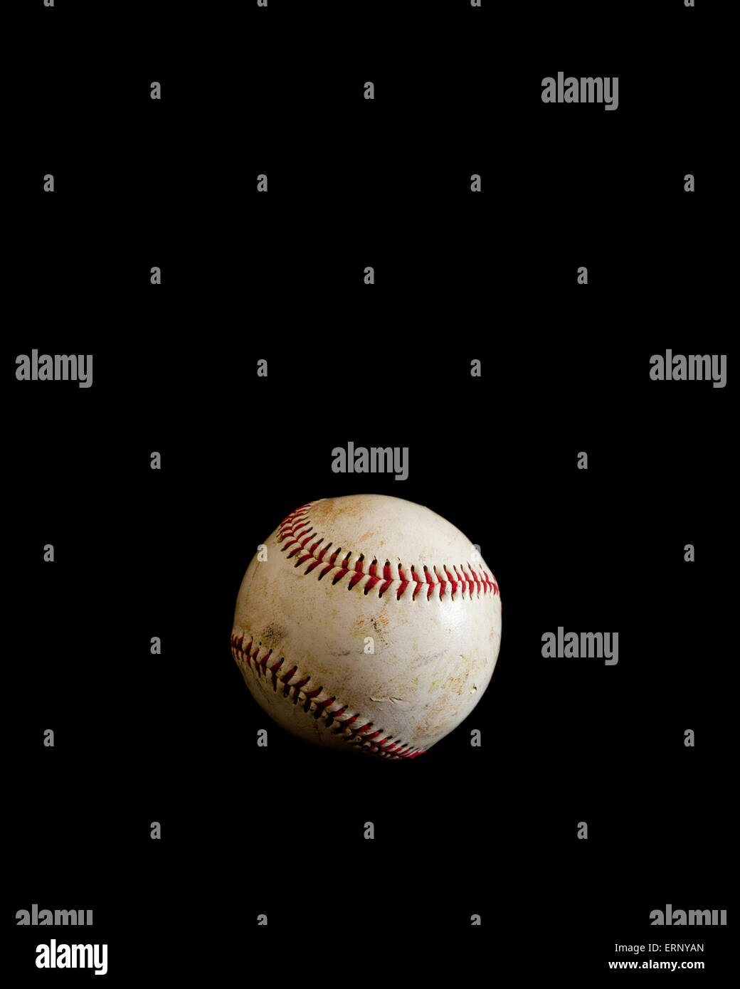 A worn baseball sits alone on a solid black background Stock Photo - Alamy