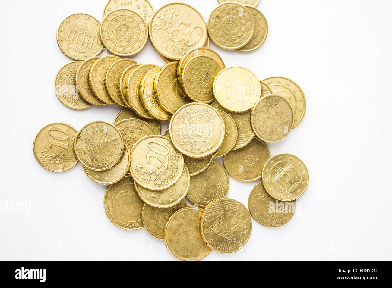 Golden European coins in white background Stock Photo - Alamy