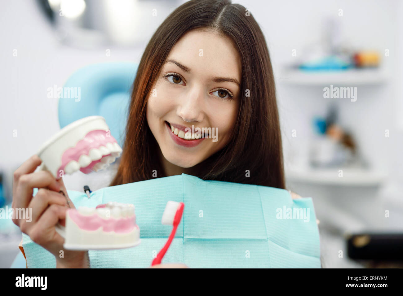 Girl with toothbrush in hand and teeth Stock Photo - Alamy