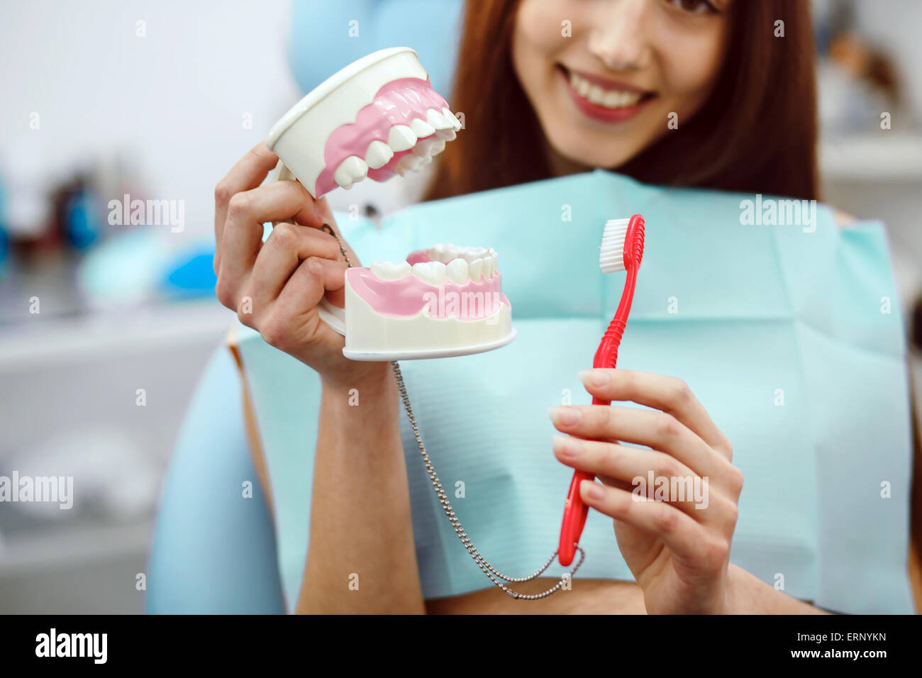 Girl with toothbrush in hand and teeth Stock Photo - Alamy
