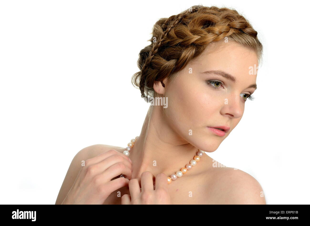 Portrait of young girl, kind face expression. Girl wears pearls and ...