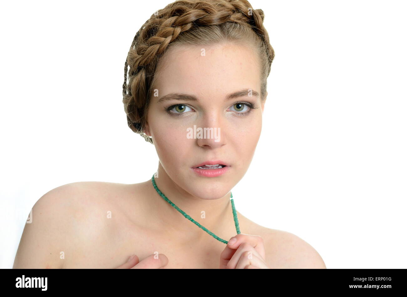 Portrait of girl with necklace made of emeralds. Female model holds ...