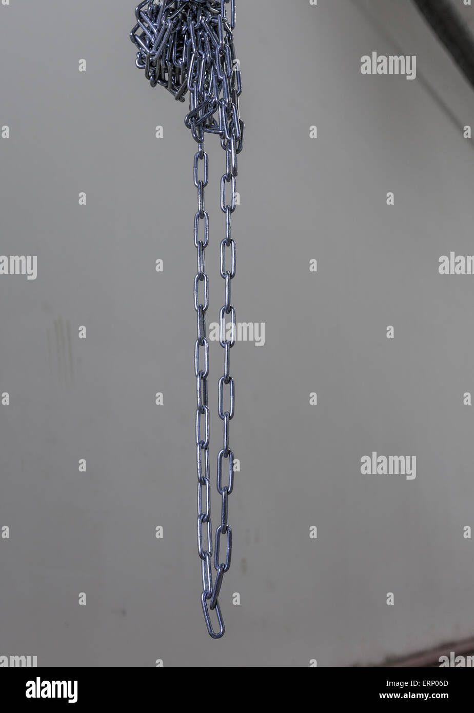 hanging from metal chain, tied in a knot Stock Photo - Alamy