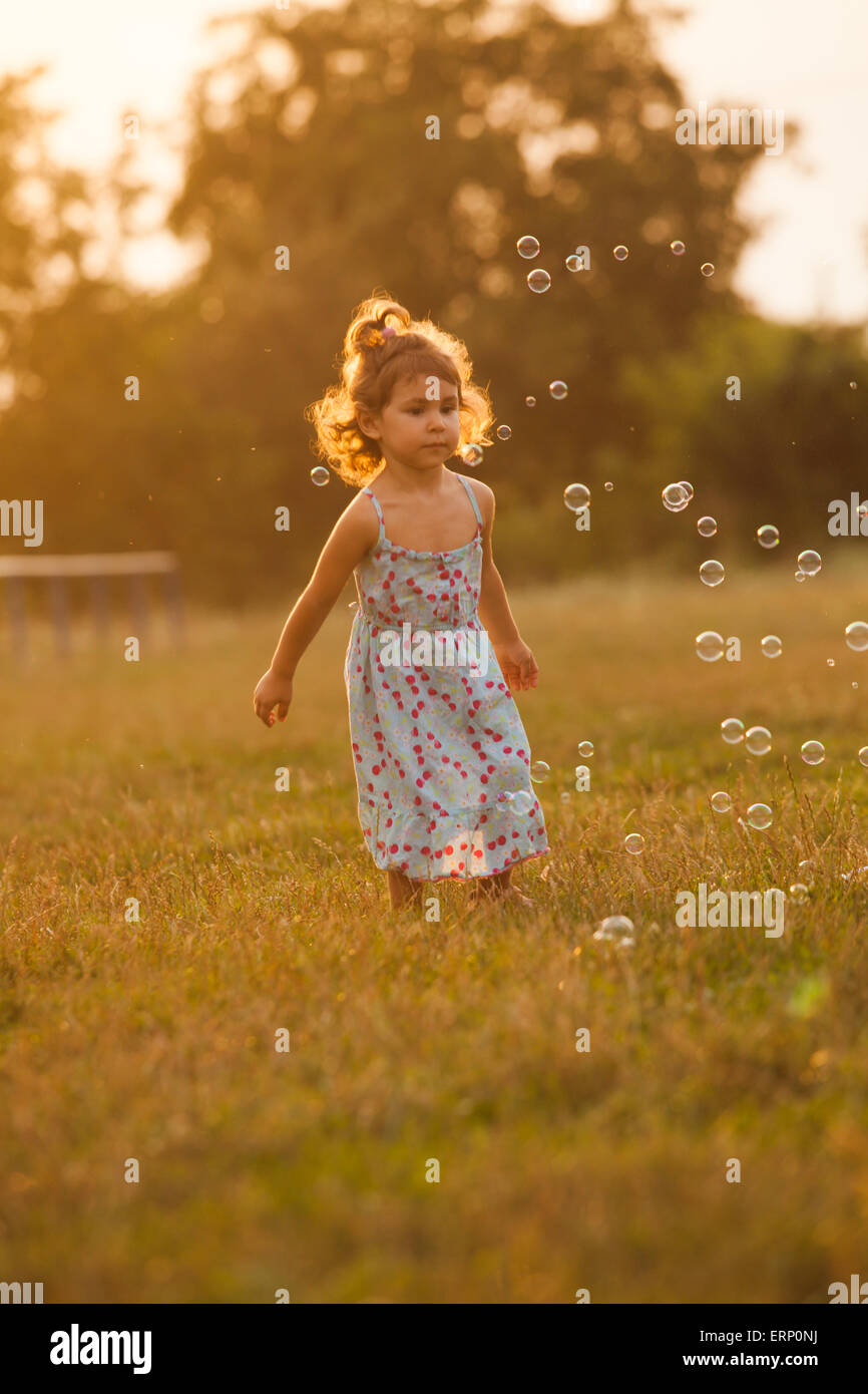 Girl blowing bubbles running hi-res stock photography and images - Alamy