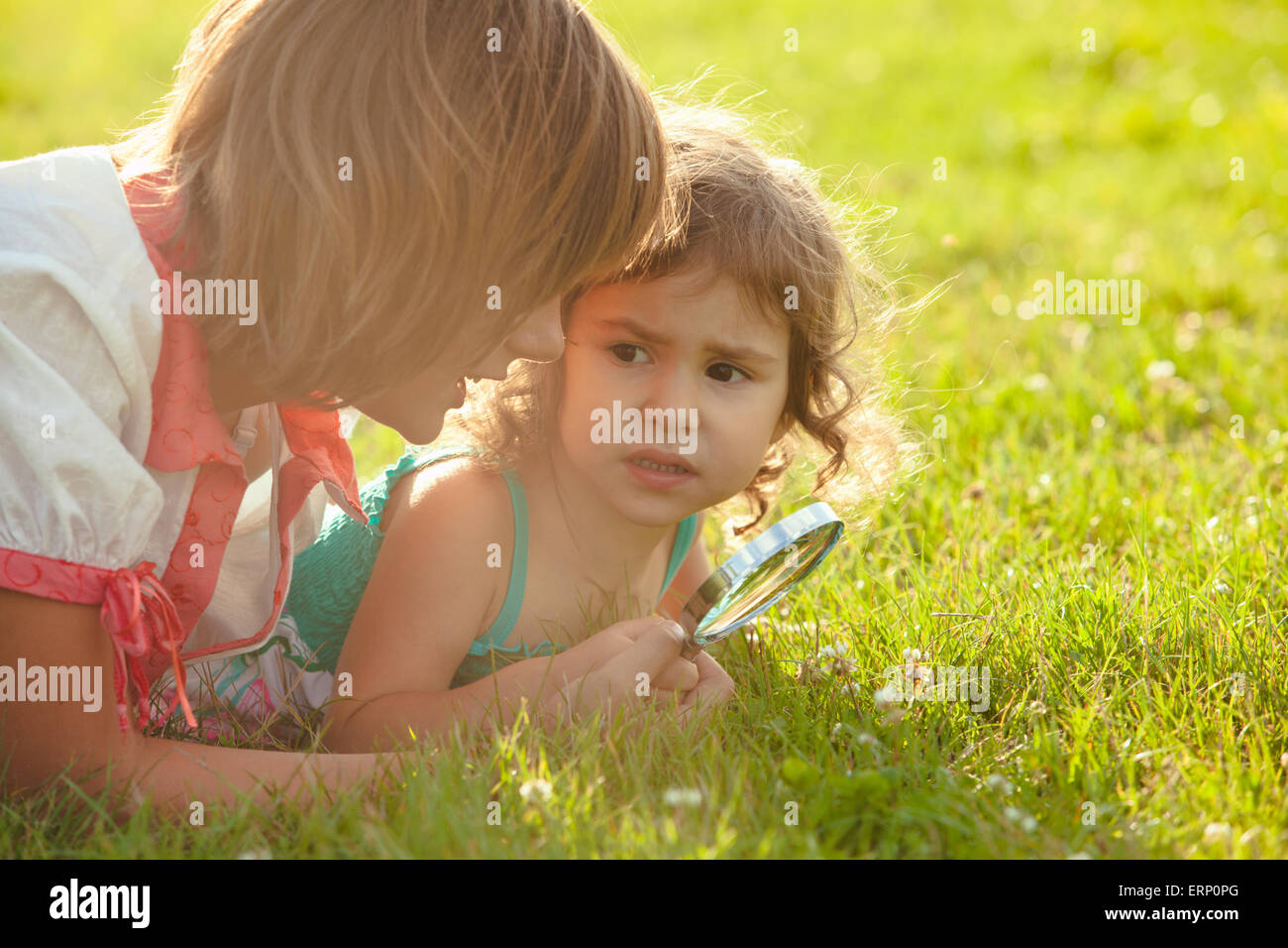 Kid with magnifying glass Stock Photo - Alamy