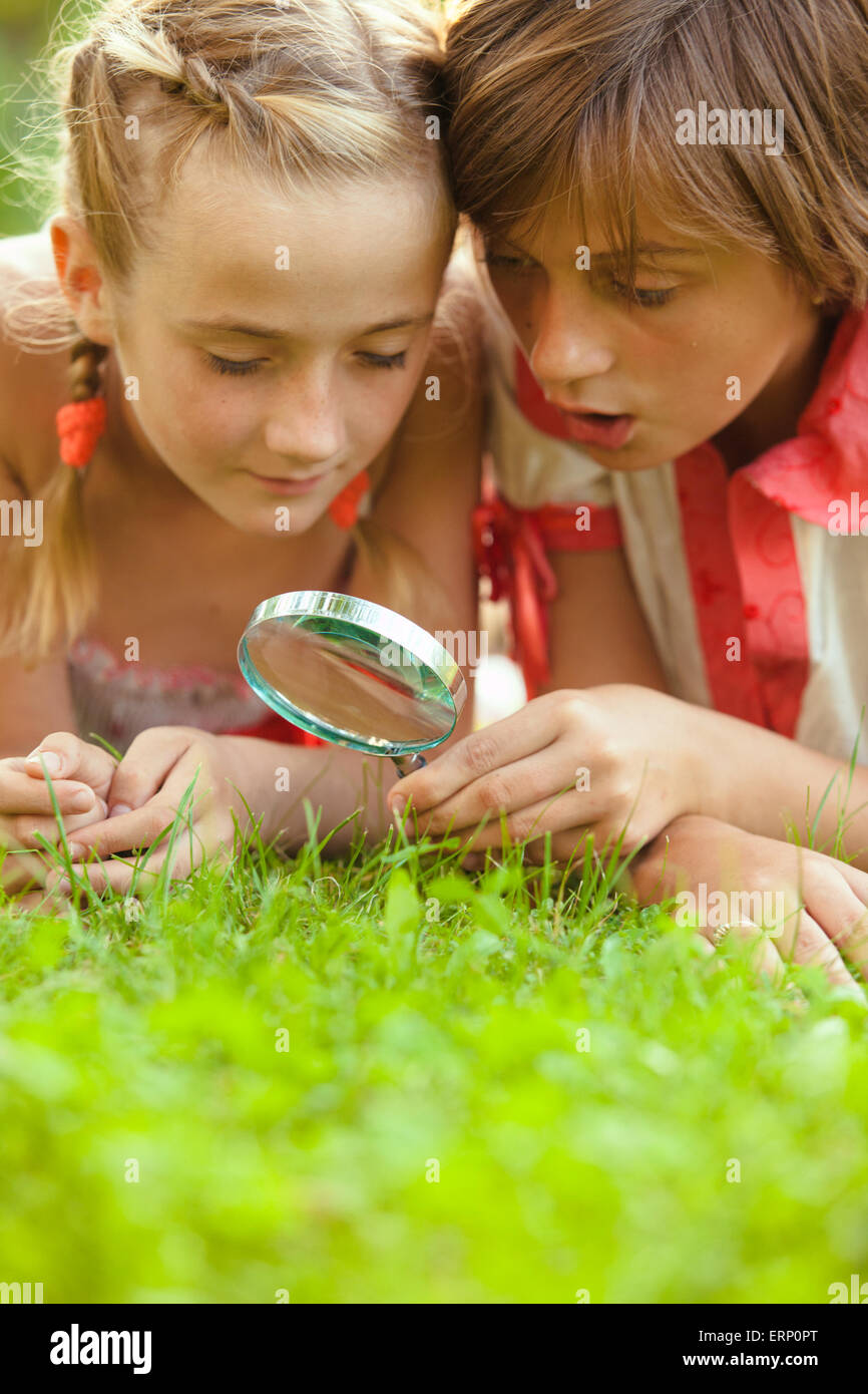 Kid with magnifying glass Stock Photo - Alamy