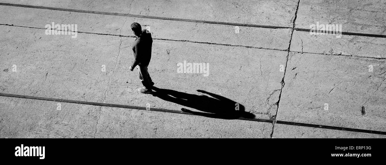 Man walking with shadow Stock Photo - Alamy