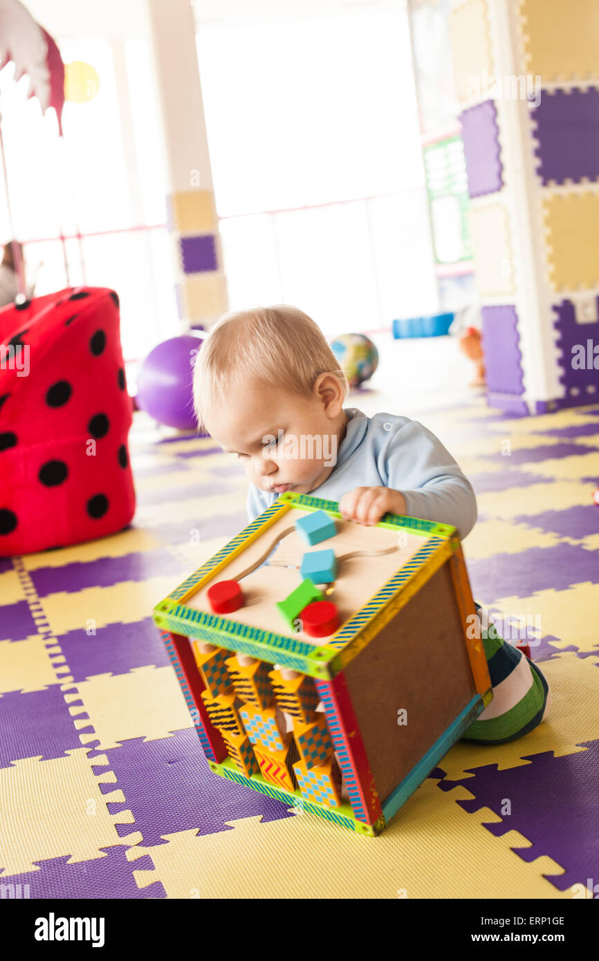 Boy plays with cube Stock Photo - Alamy