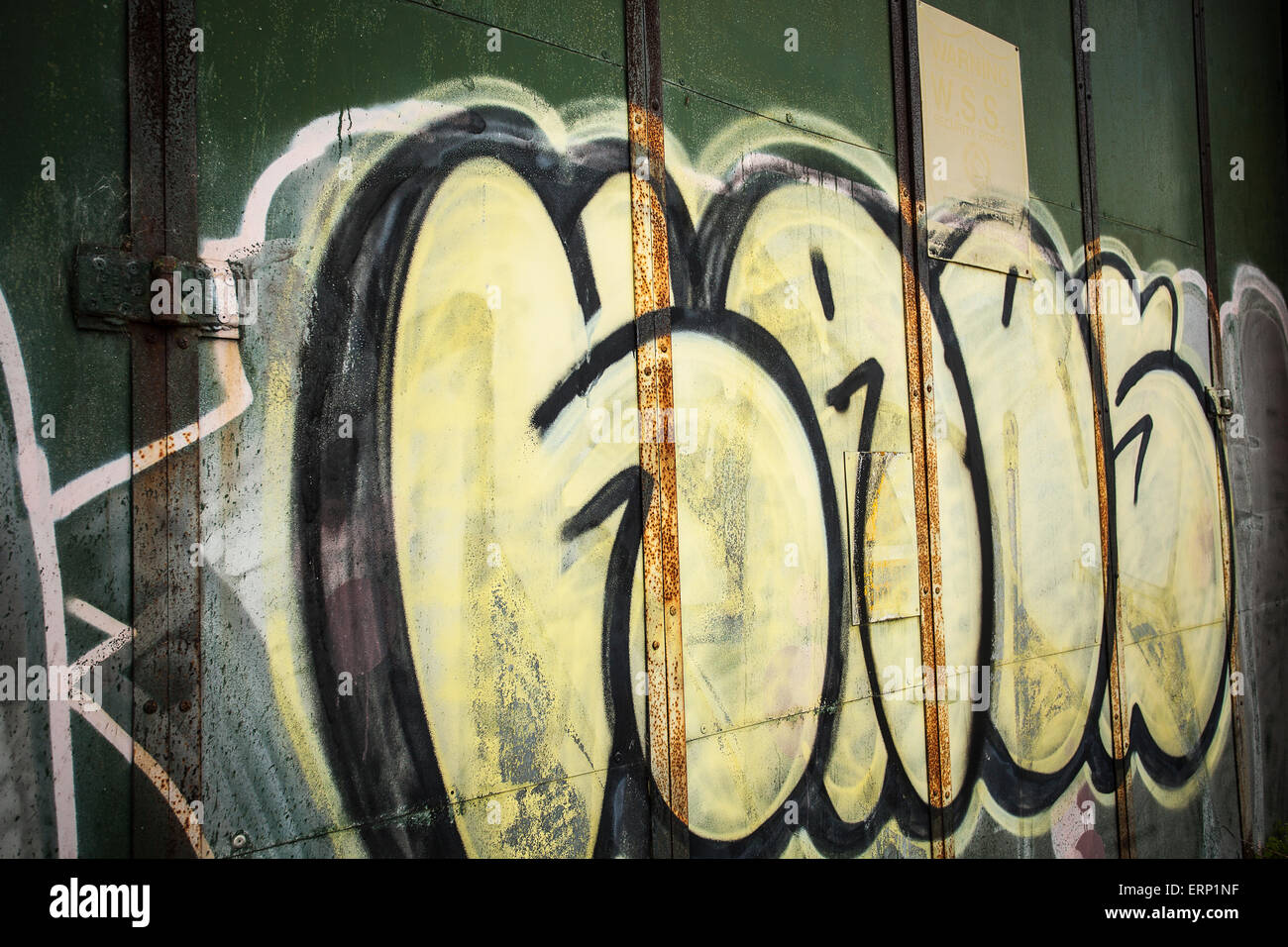 Graffiti on a green wall Stock Photo - Alamy