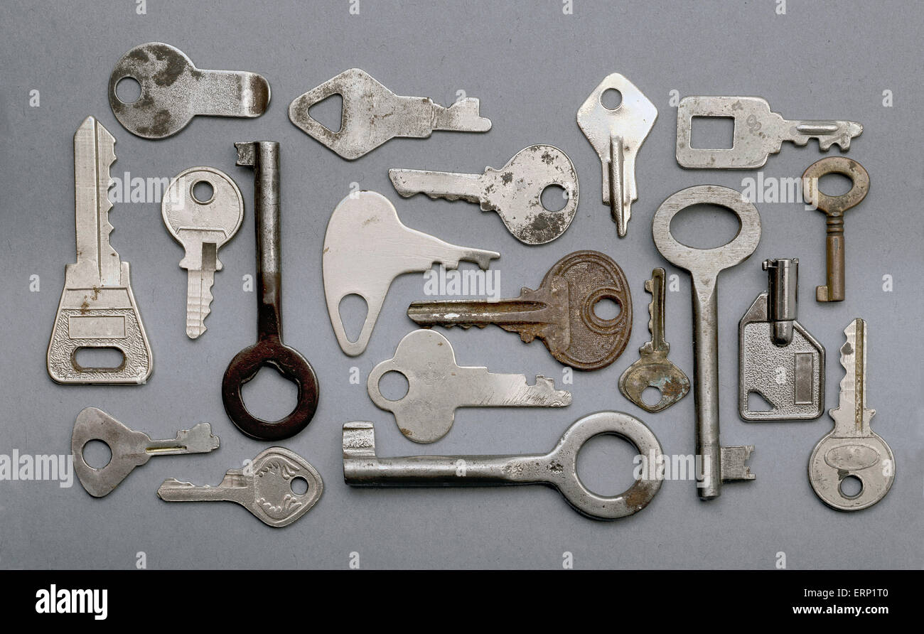 Several keys ancient and modern, over gray background Stock Photo - Alamy
