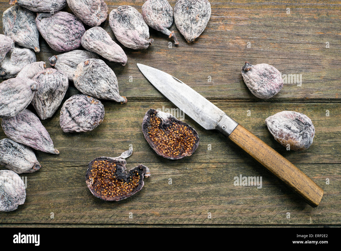 knife and figs on an old wooden table Stock Photo - Alamy