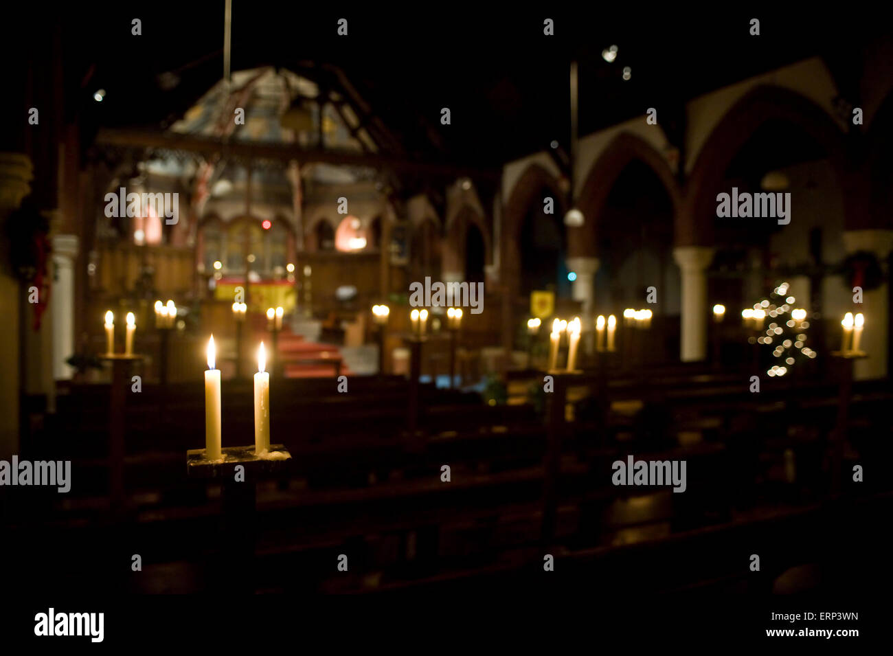The interior of a church at Christmas time - Candles alight in a church ...