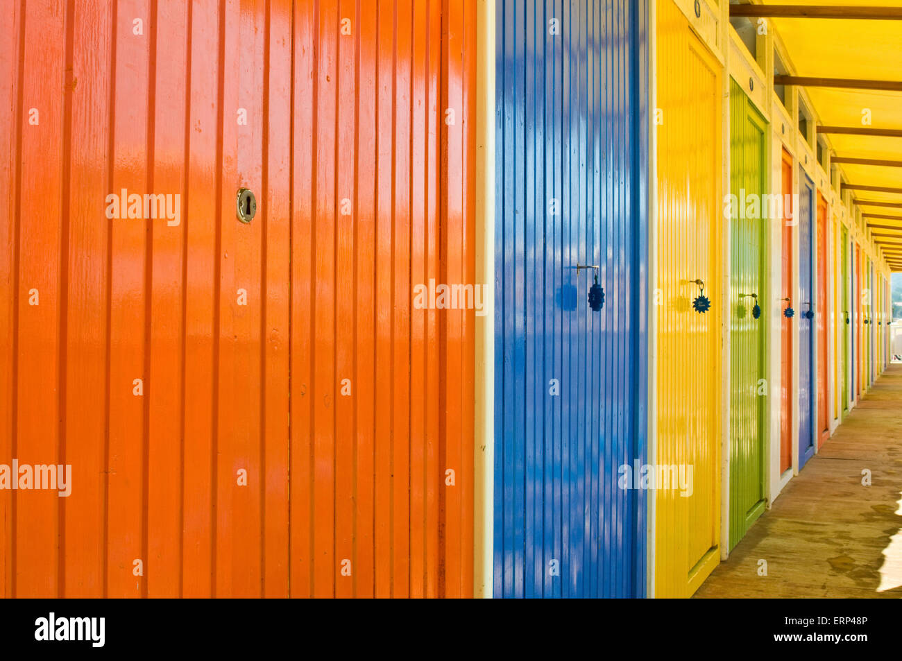 Brightly coloured beach hut changing rooms Stock Photo - Alamy