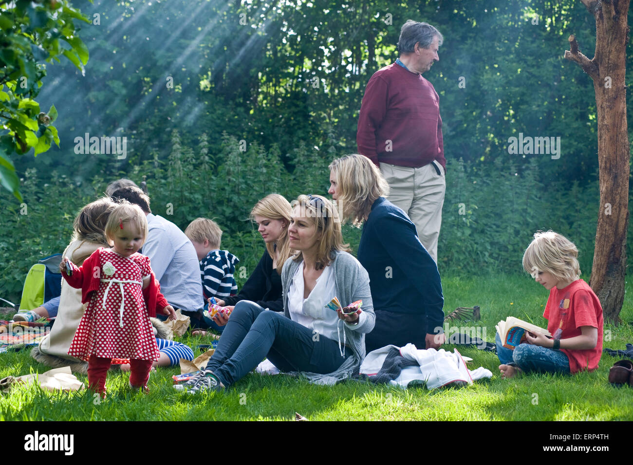 A family gathering with three generations of children, parents and ...