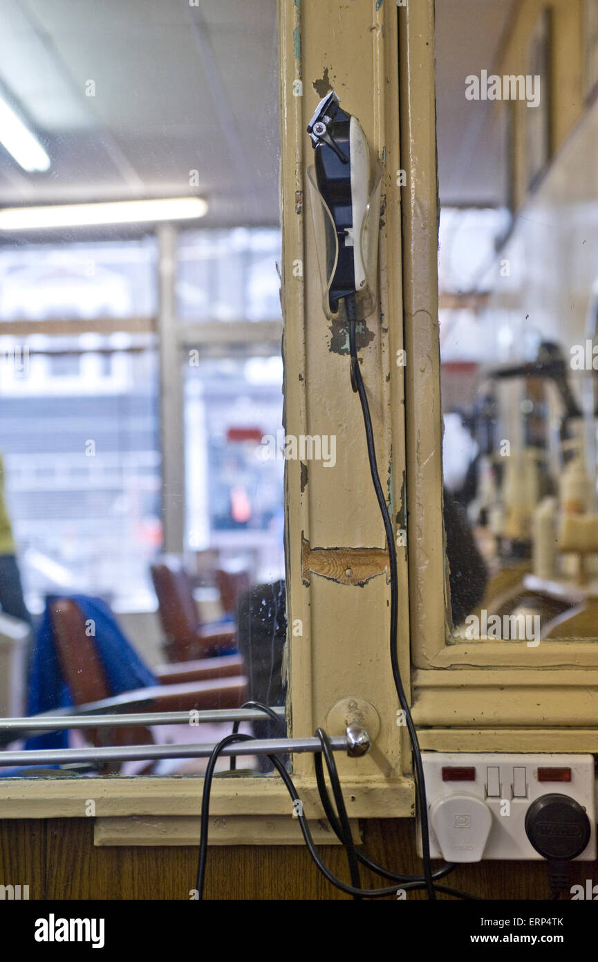 An old, run down traditional barbers electric razer and hair dryer ...