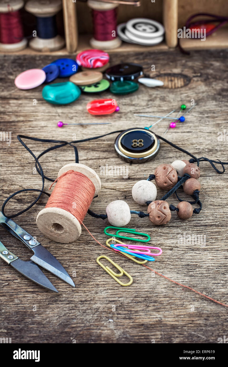 set of threads and buttons on wooden background.Selective focus Stock ...