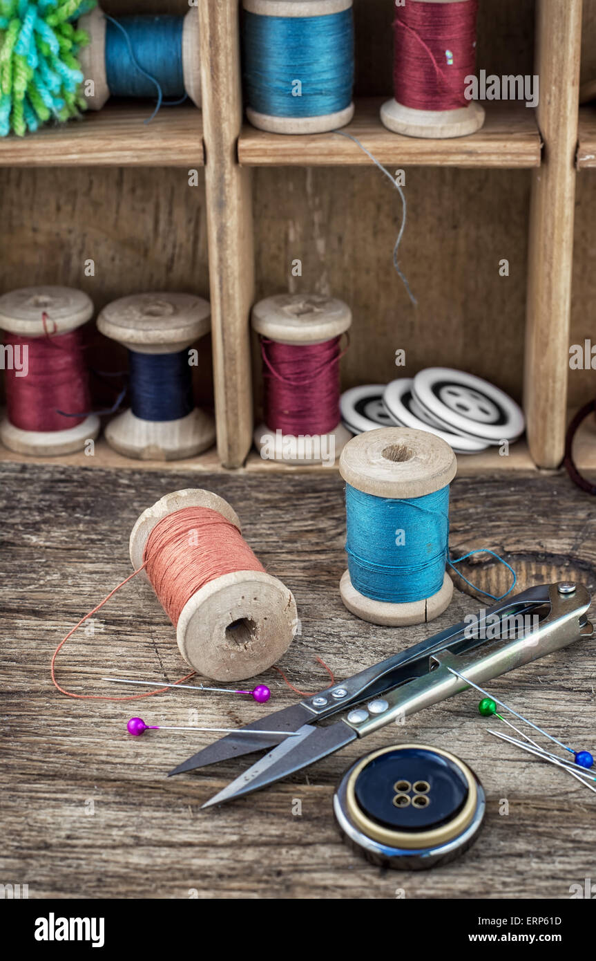 set of threads and buttons on wooden background.Selective focus Stock ...