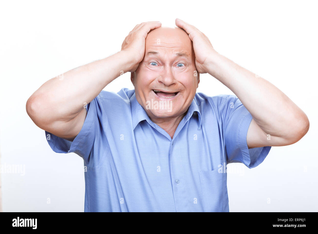Joyful grandfather touching his head Stock Photo - Alamy