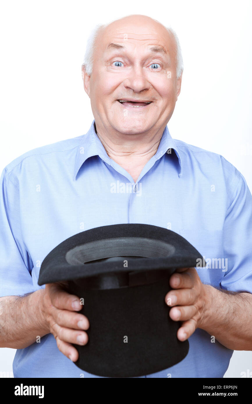 Smiling grandfather standing with hat Stock Photo - Alamy