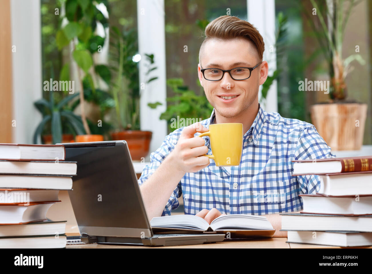 Young student working in a library Stock Photo - Alamy