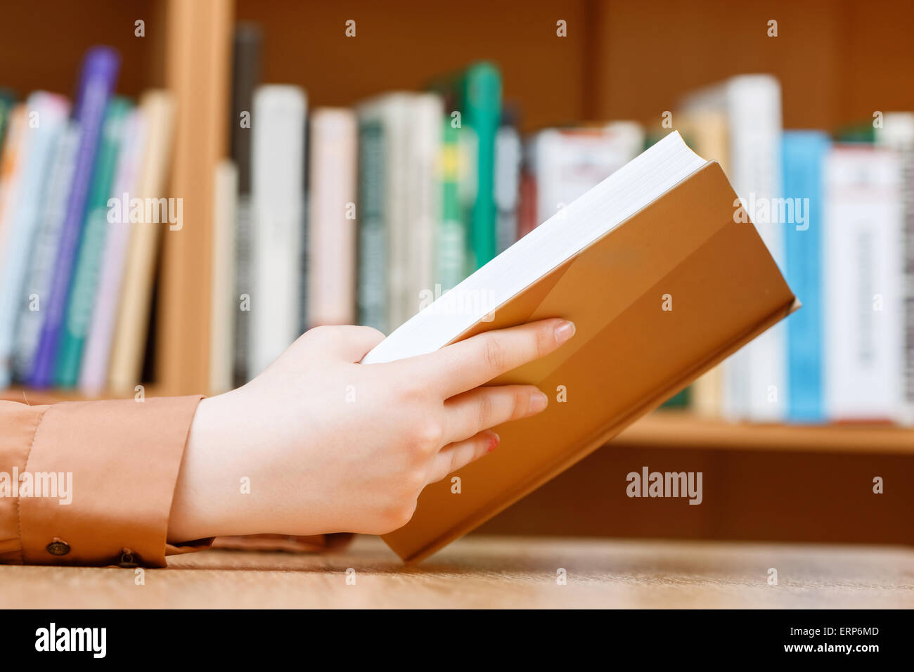 Woman hands in a library Stock Photo - Alamy