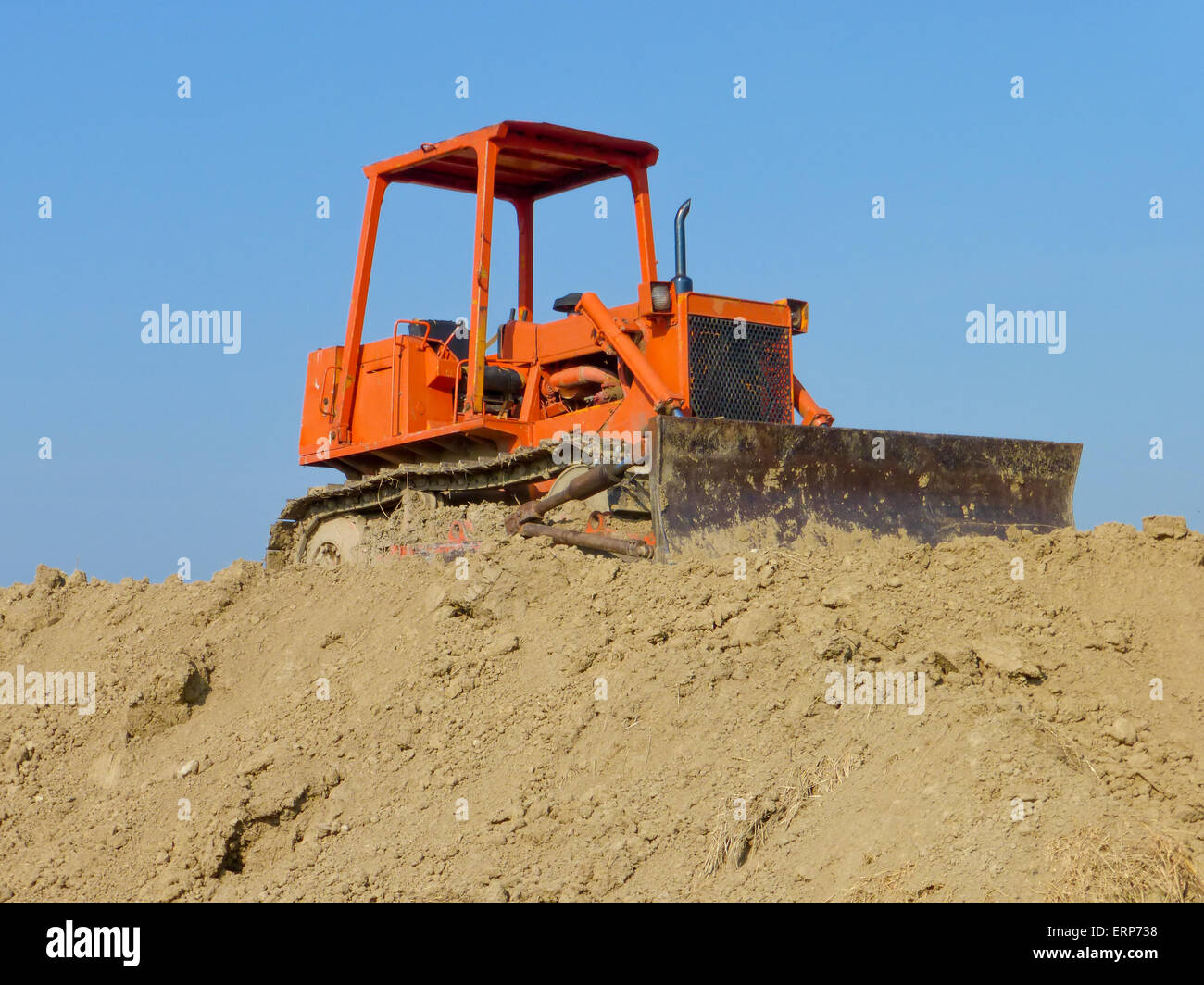 old orange bulldozer stops waiting for work Stock Photo - Alamy