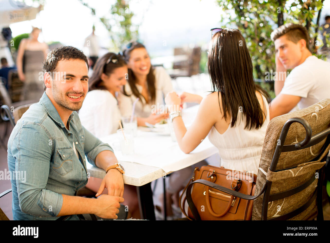 Young people by the table Stock Photo - Alamy