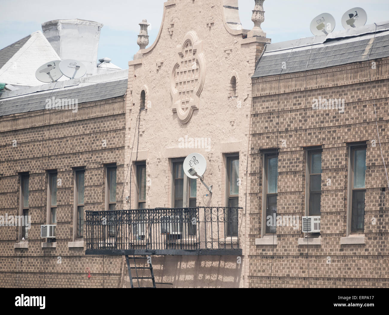 A Dish Network satellite dish on the wall of a building in the New York ...