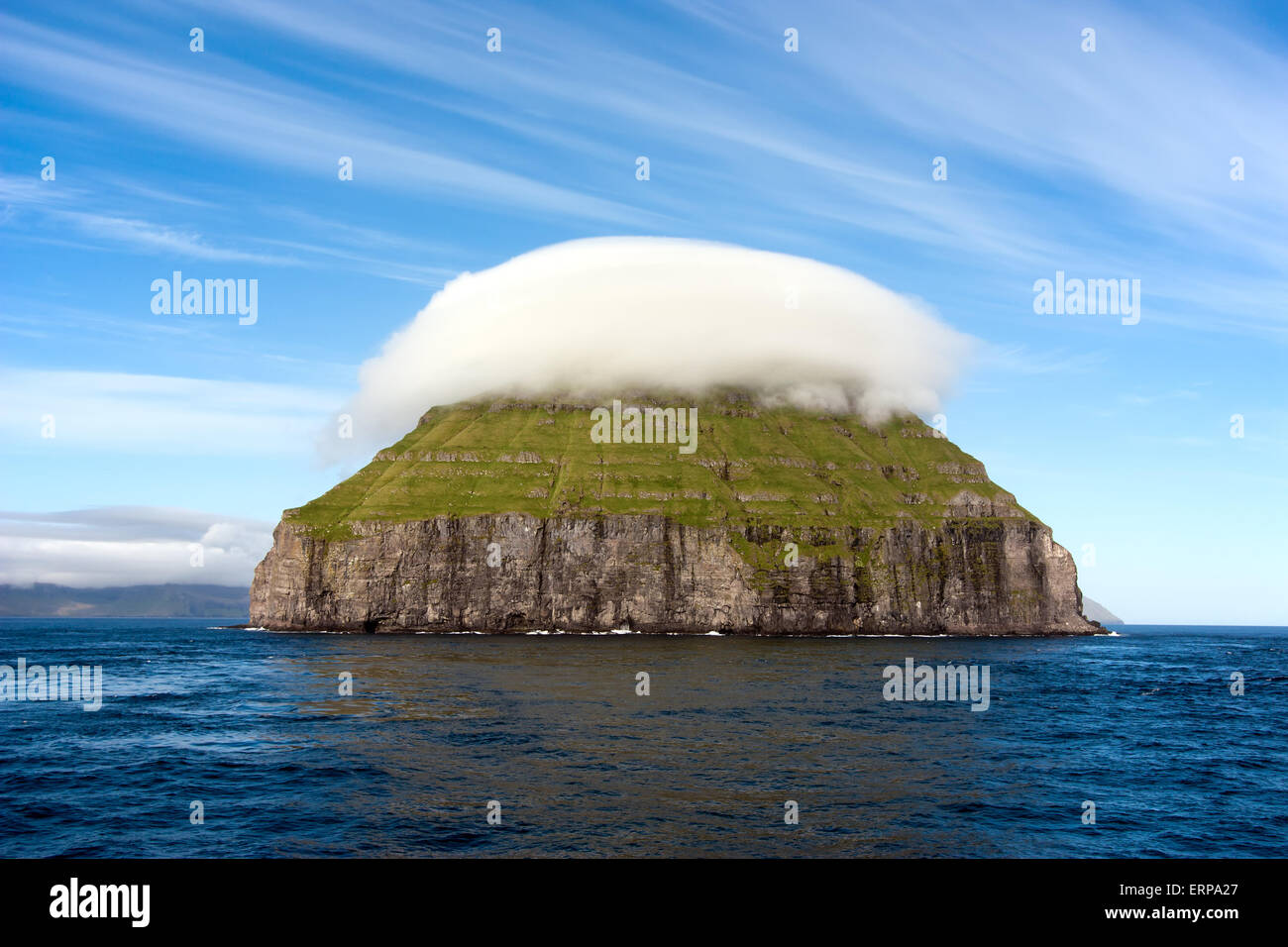 Remote rocky island covered by a cap of clouds Stock Photo - Alamy