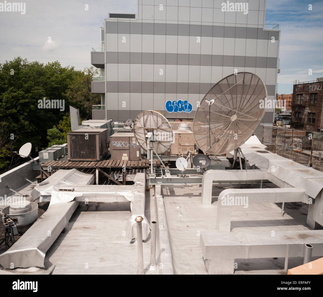 A Dish Network satellite dish amidst other contemporary and outdated ...